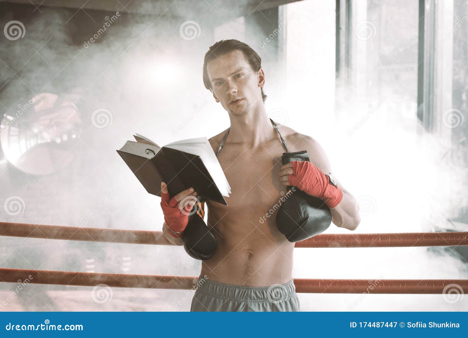 Professional Boxer Having Break during Training and Reading a Book ...