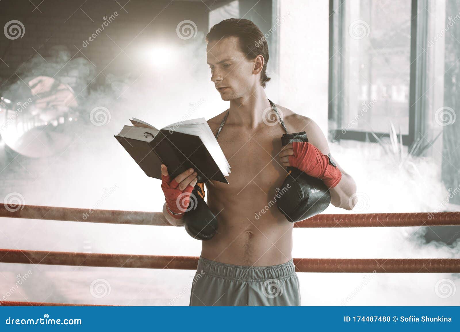 Professional Boxer Having Break during Training and Reading a Book ...