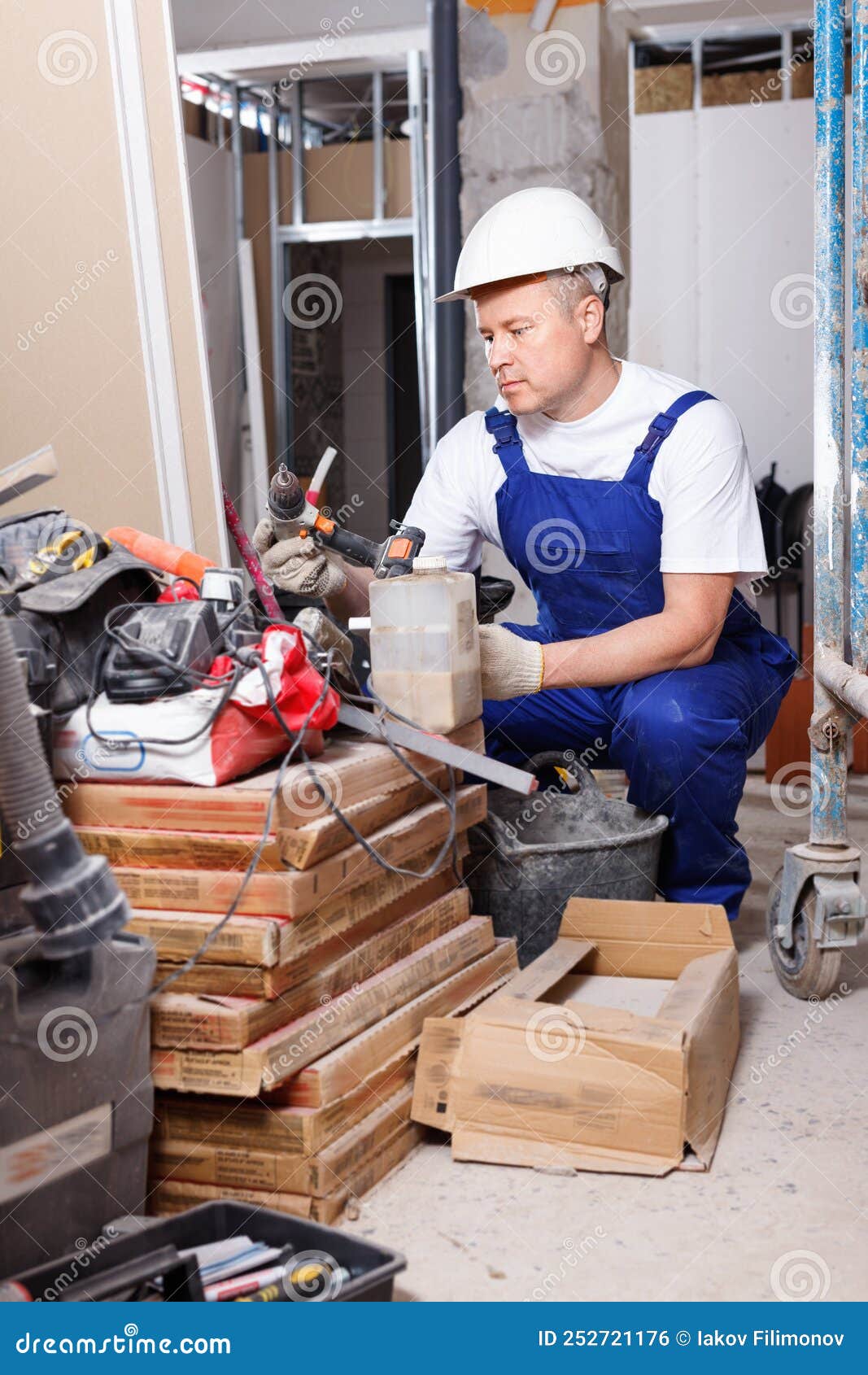 Professional Builder Checking Tools and Materials while Getting Ready ...