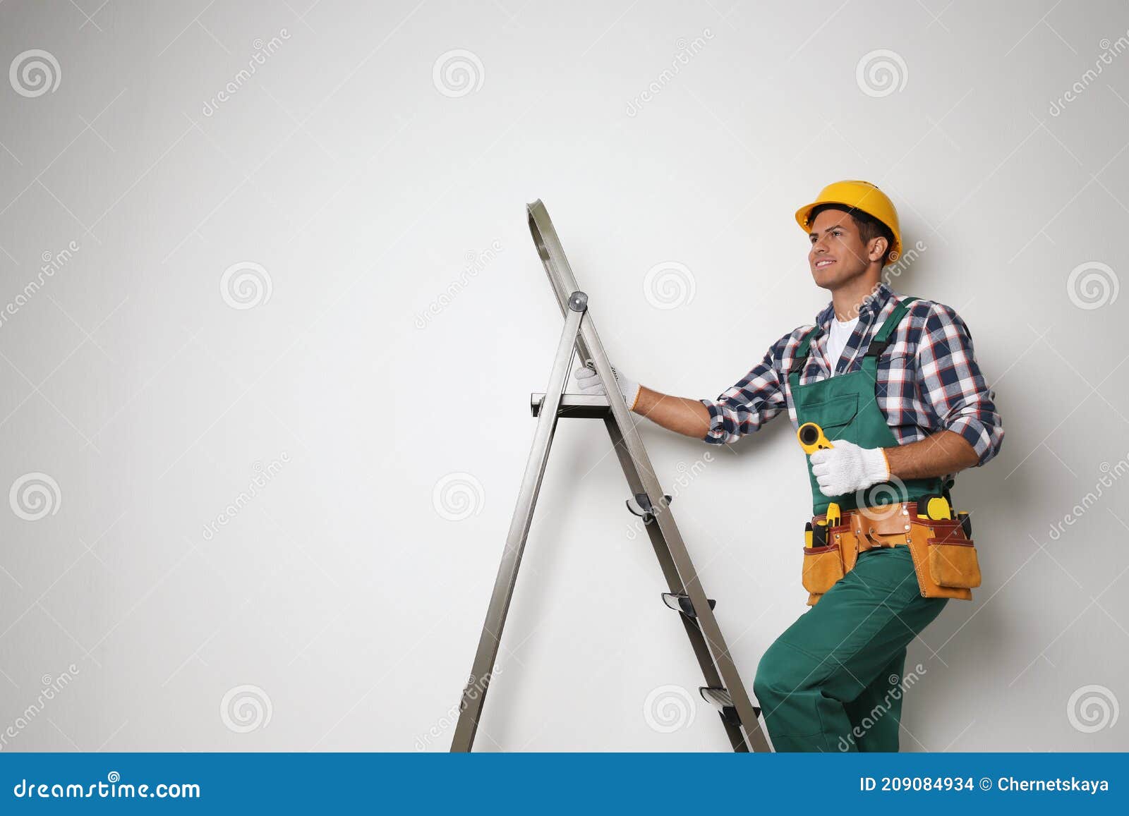 Professional Builder Climbing Up Metal Ladder on Light Background ...