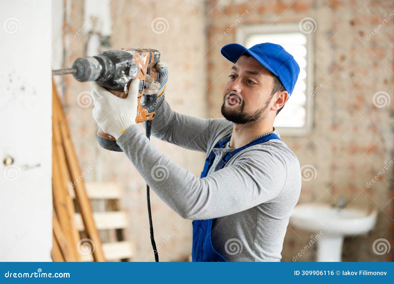 Professional Builder Drilling Hole in Wall with Perforator in ...