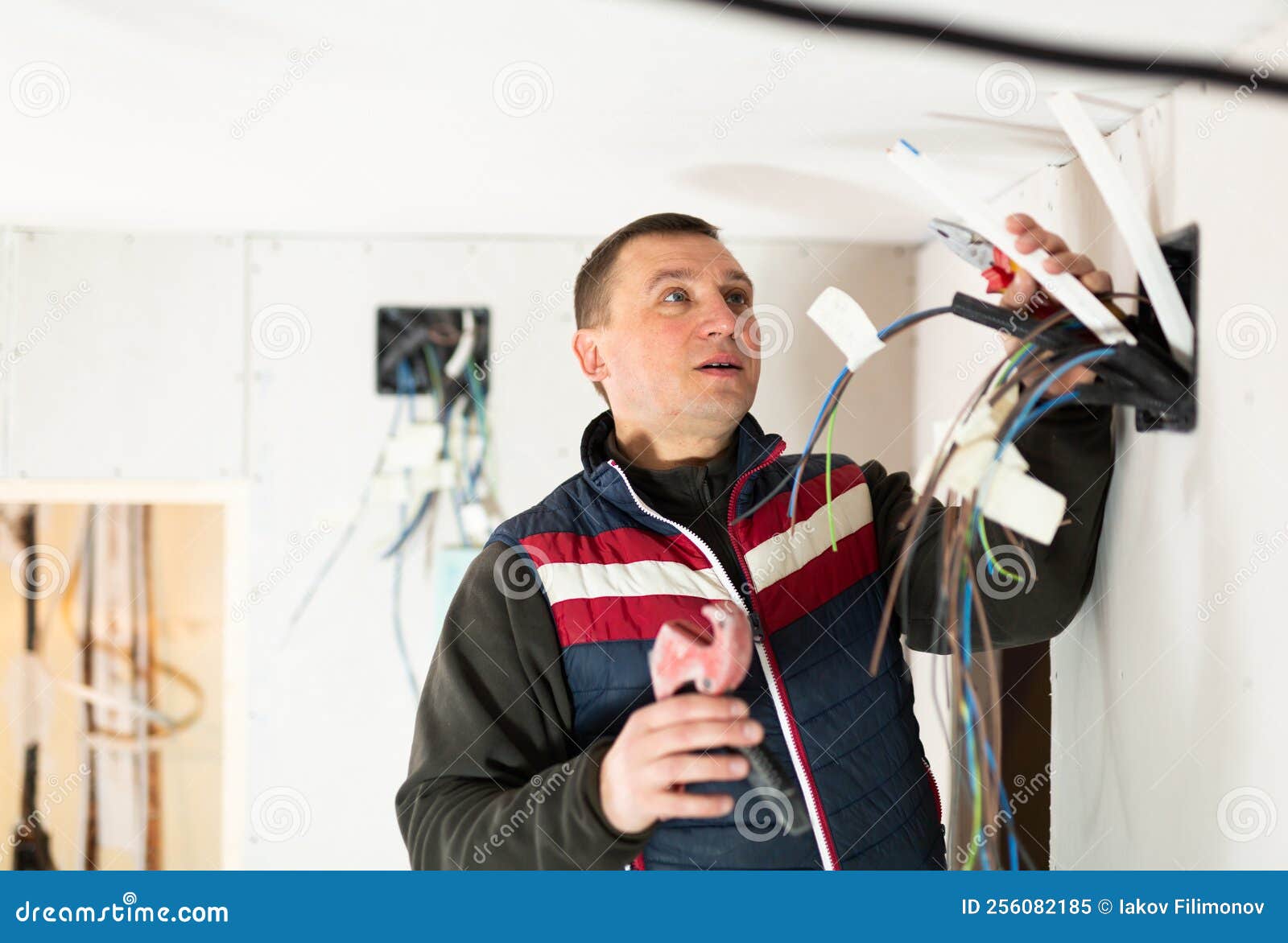 Professional Builder Engaged in Electrical Installation Work at Indoors ...