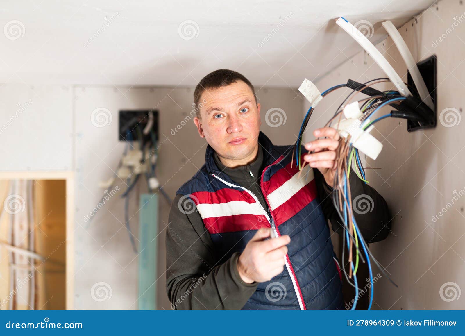 Professional Builder Engaged in Electrical Installation Work at Indoors ...
