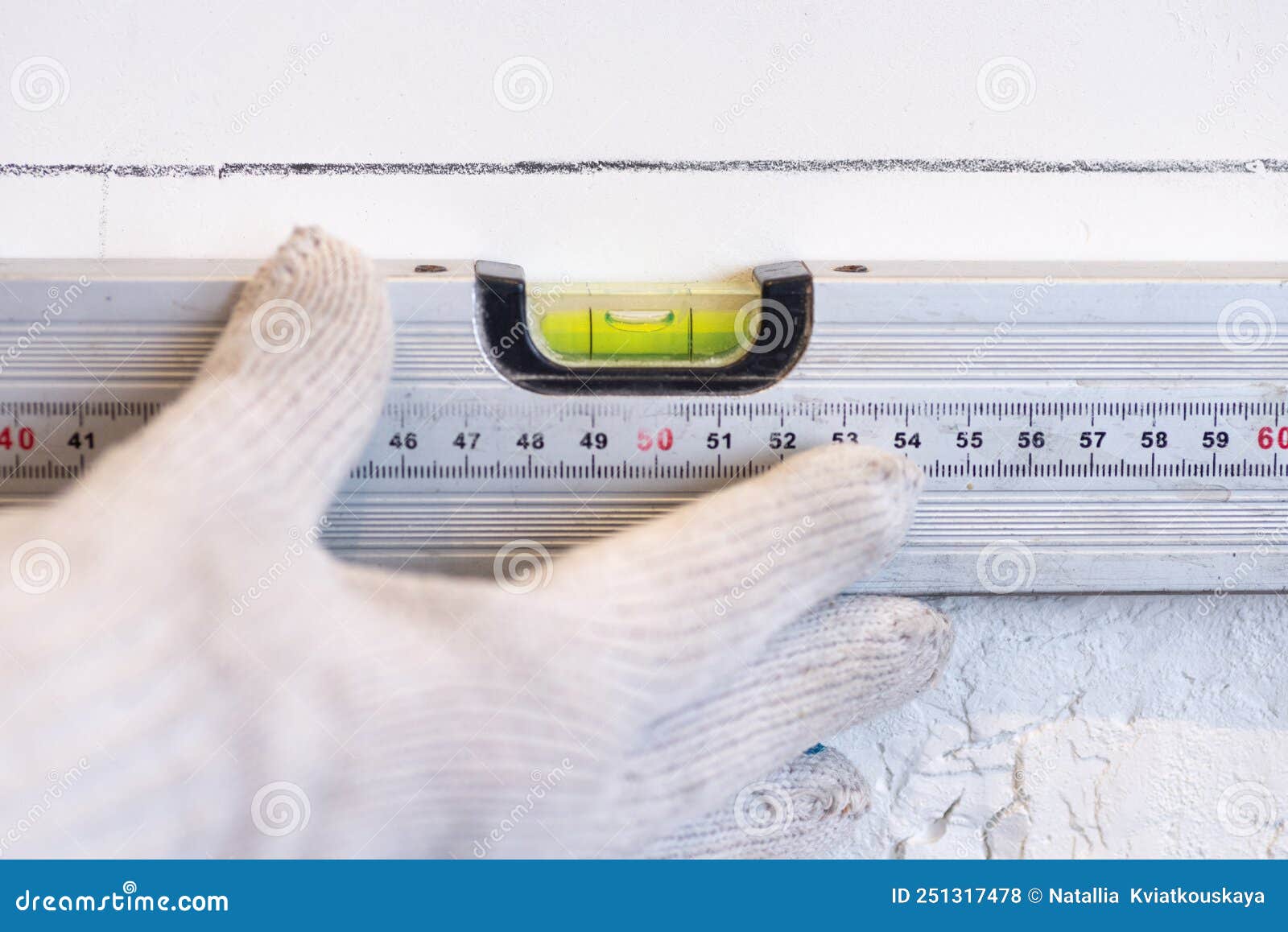 A Professional Builder Sticks Decorative Tiles on the Wall. Uses ...