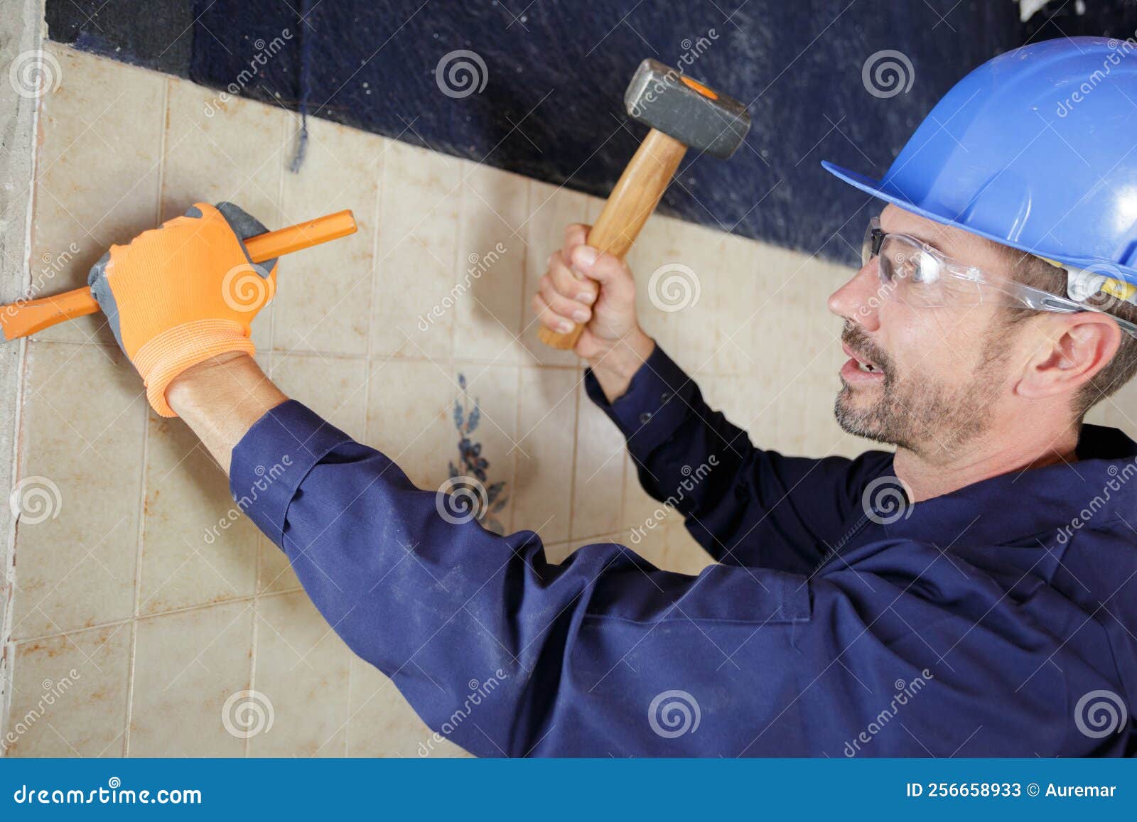 Professional Builder Using Hammer and Chisel on Wall Stock Image ...