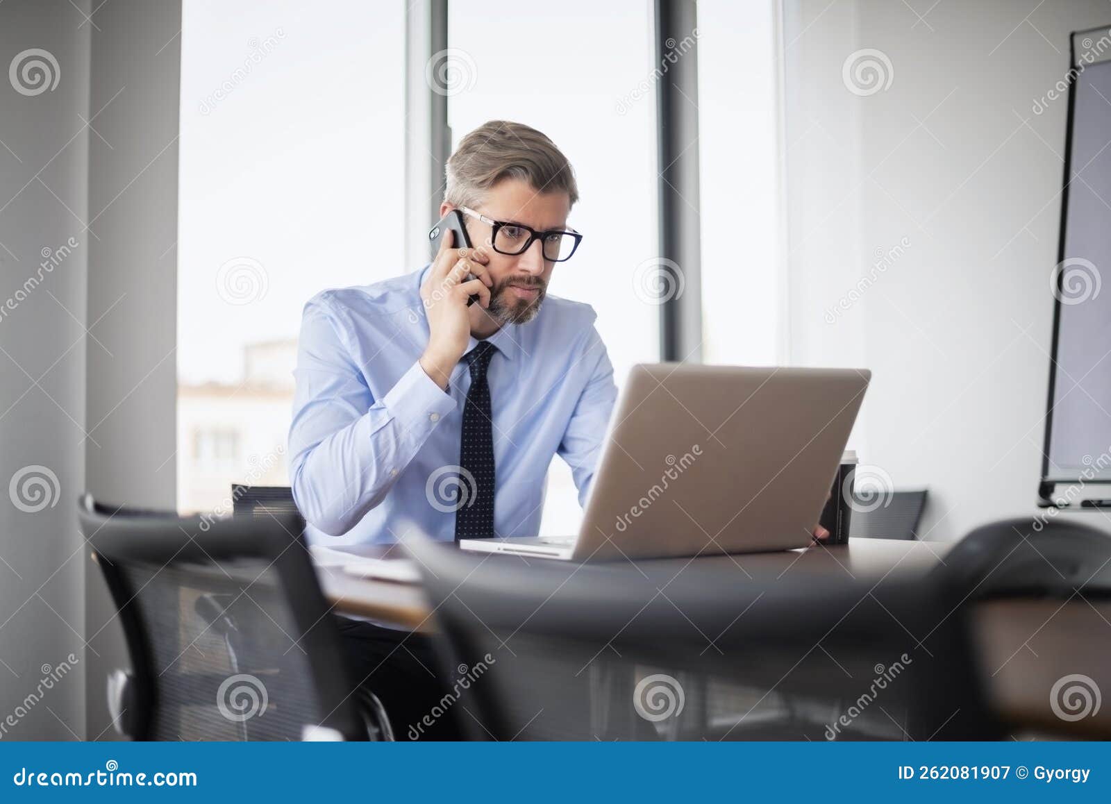 Professional Businesman Using Cellphone and Laptop at Work Stock Image ...