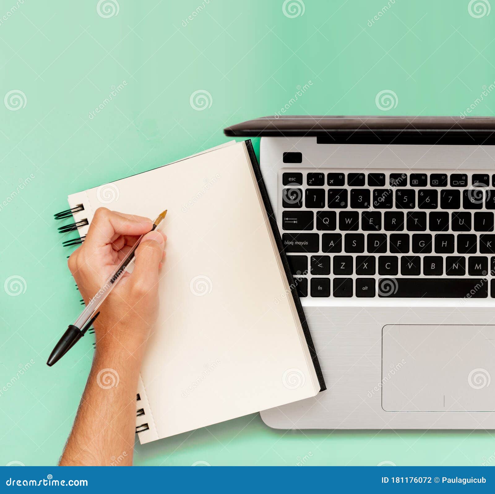 Professional Businessman Writing in Notepad. Workspace with Laptop and ...