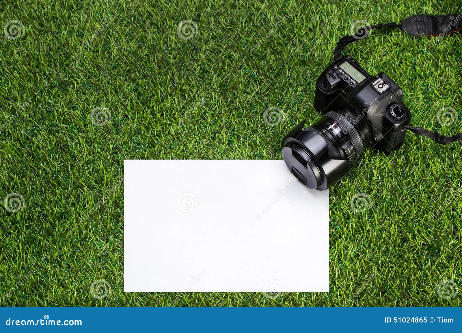 Professional Camera with Sheet of Paper Lying on the Grass Stock Image ...