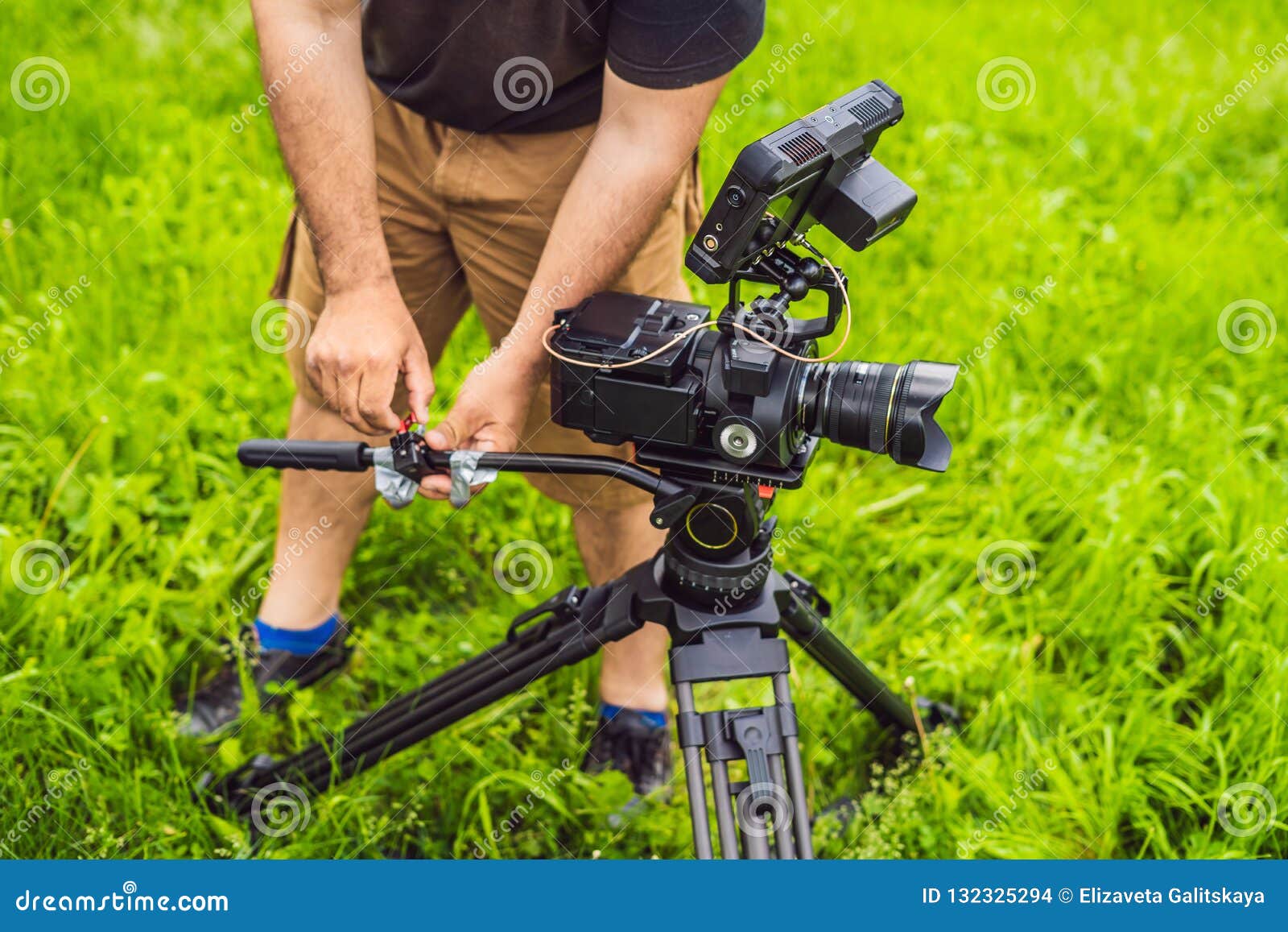 A Professional Cameraman Prepares a Camera and a Tripod before Shooting ...