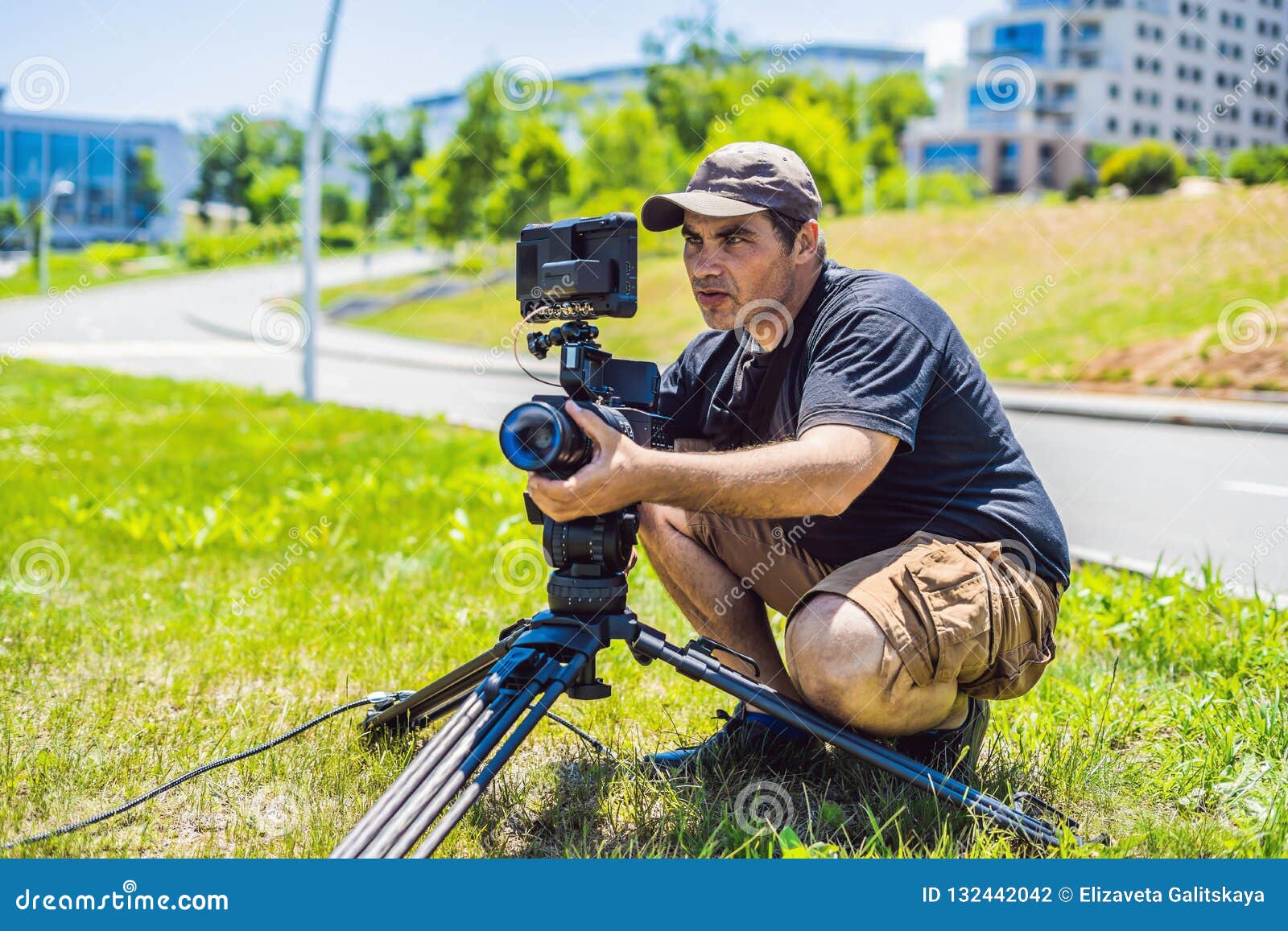 A Professional Cameraman Prepares a Camera and a Tripod before Shooting ...