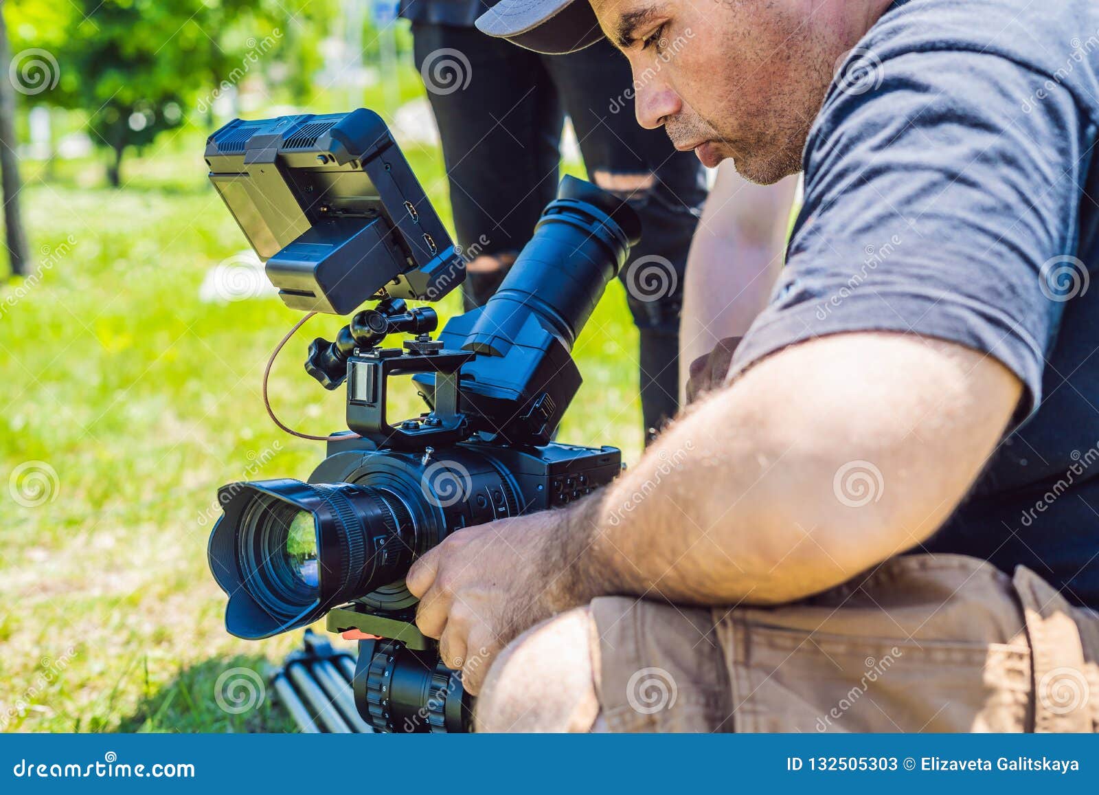 A Professional Cameraman Prepares a Camera and a Tripod before Shooting ...