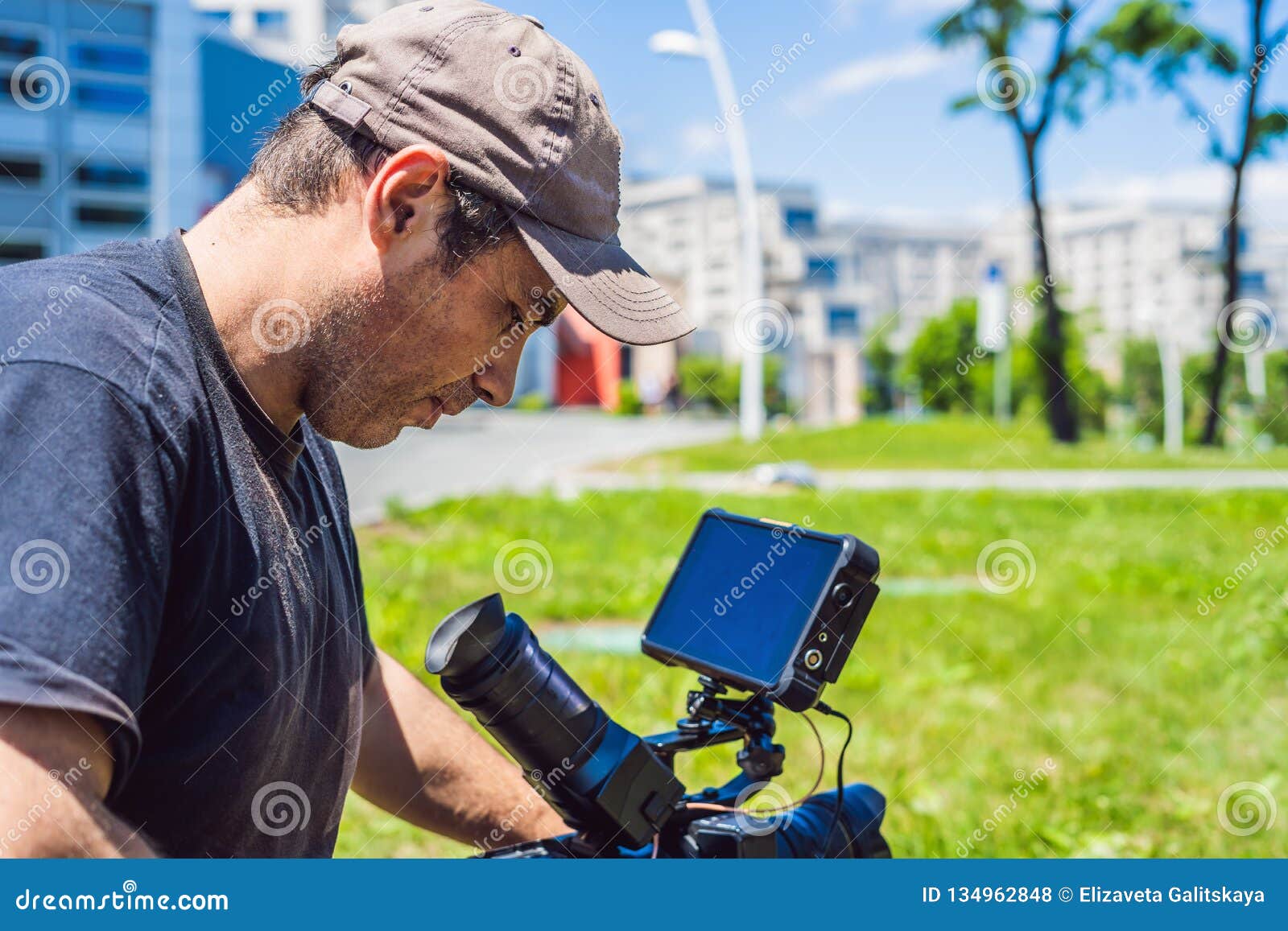 A Professional Cameraman Prepares a Camera and a Tripod before Shooting ...
