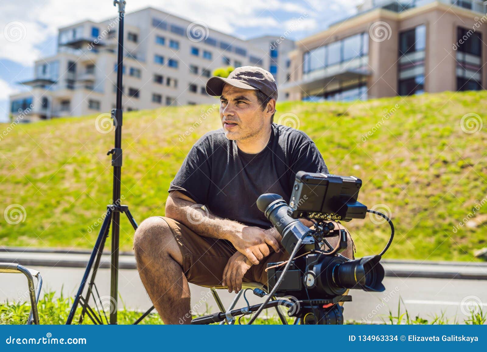 A Professional Cameraman Prepares a Camera and a Tripod before Shooting ...