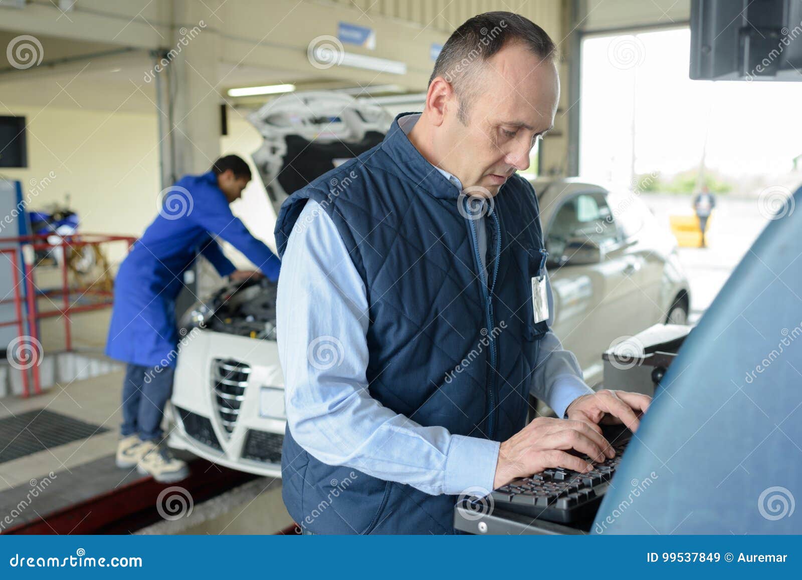 Professional Car Mechanic at Workplace Using Laptop Stock Image - Image ...