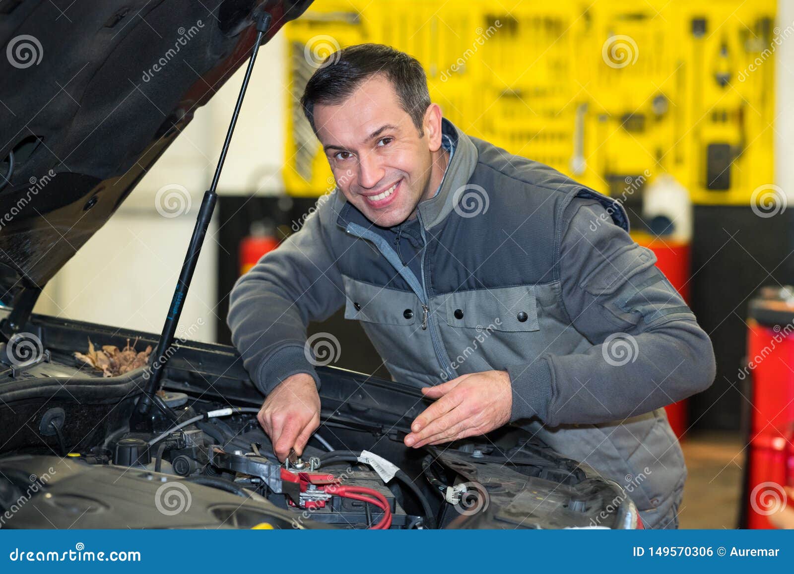Professional Car Mechanic Smiling To Camera while Working Stock Photo ...