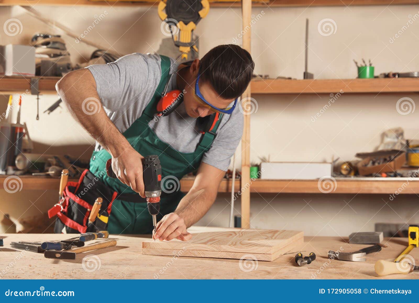 A Professional Carpenter Makes A Product From Wooden Boards And Slats ...