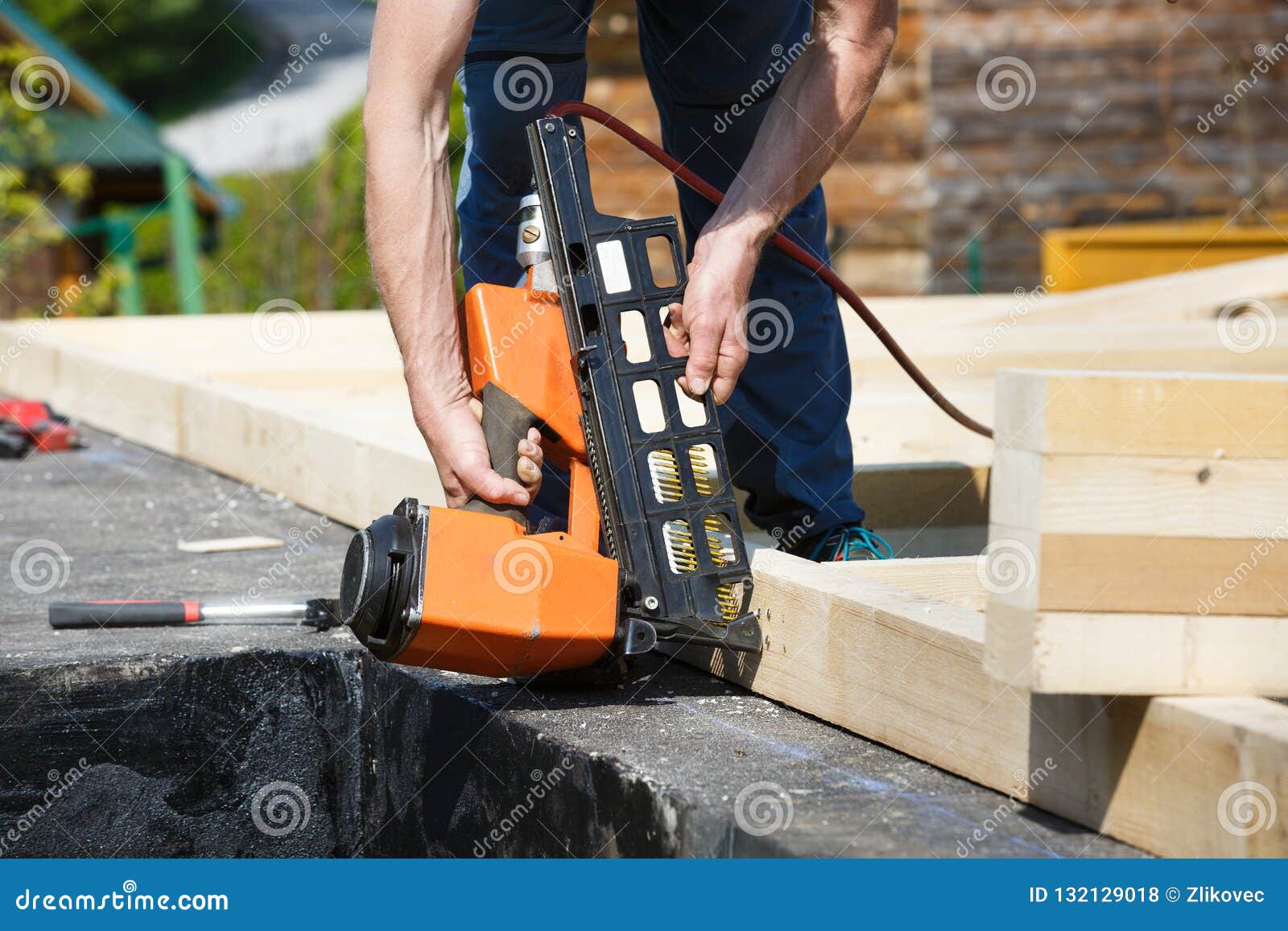 Professional Carpenter Using Pneumatic Nail Gun Stock Photo - Image of ...