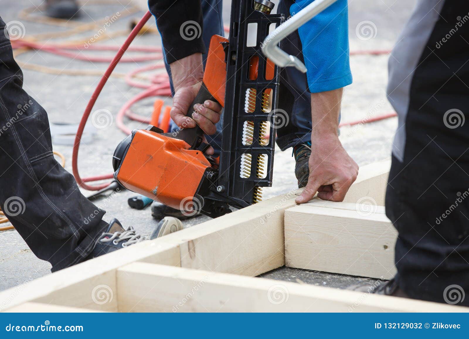 Professional Carpenter Using Pneumatic Nail Gun Stock Photo - Image of ...