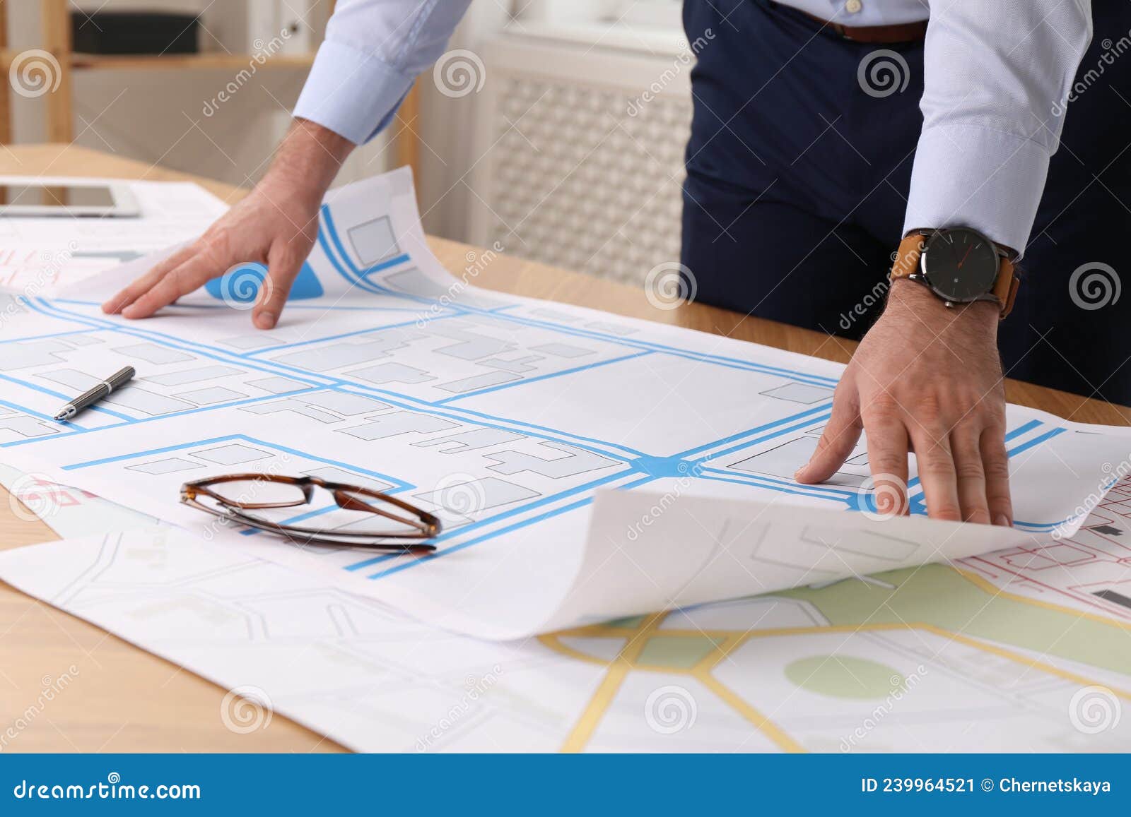 Professional Cartographer Working with Cadastral Map at Table in Office ...