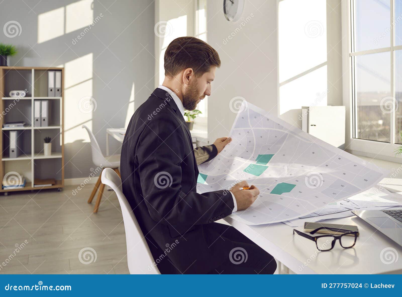 Professional Cartographer Working with Printed Cadastral Map at Table ...