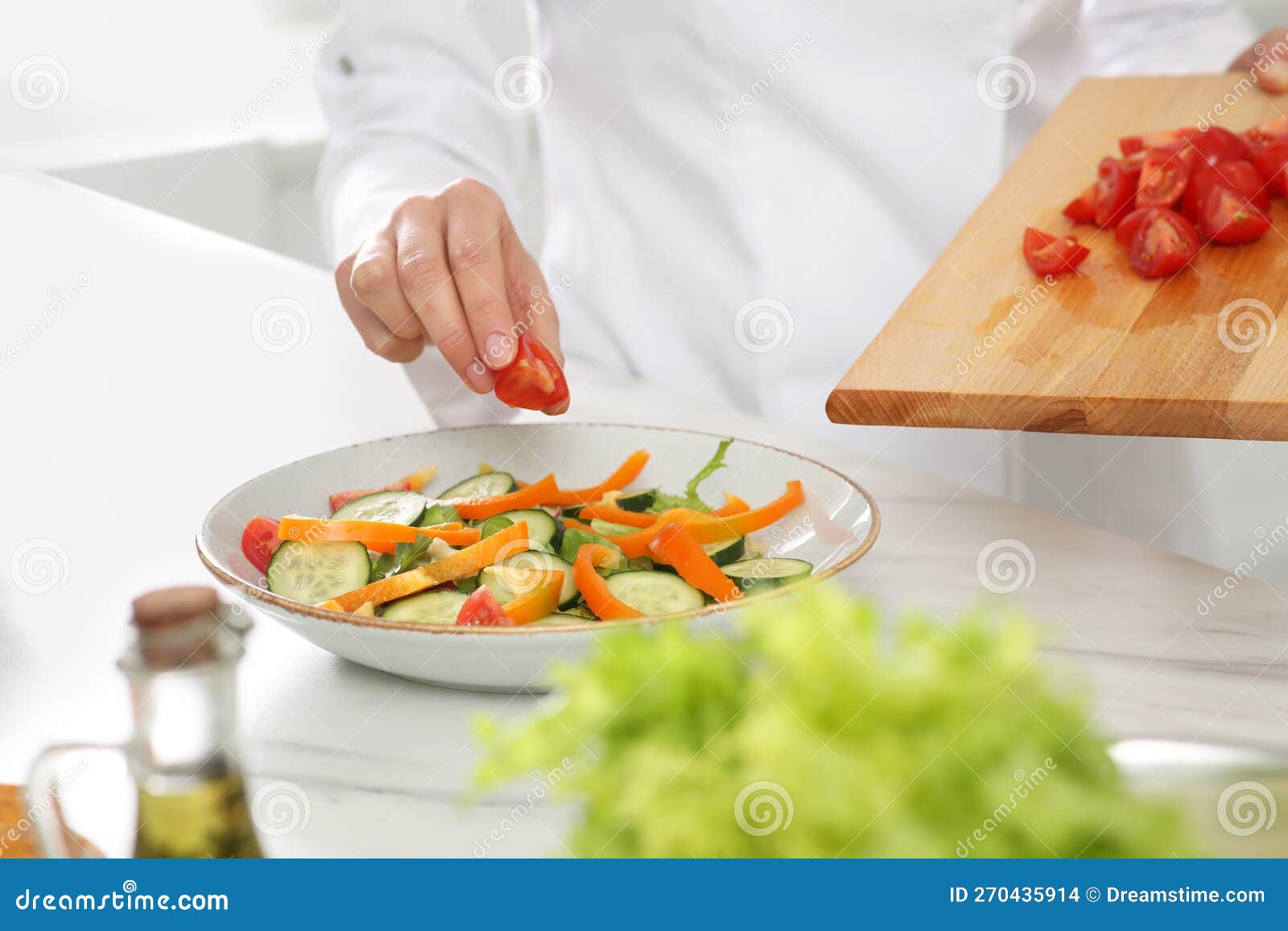 Professional Chef Adding Cut Tomato into Delicious Salad at White ...