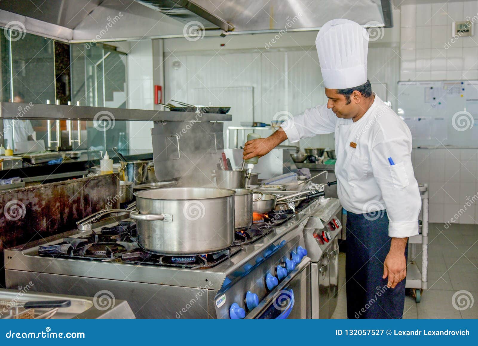 Professional Chef Adding Ingredients To the Dish while Cooking ...