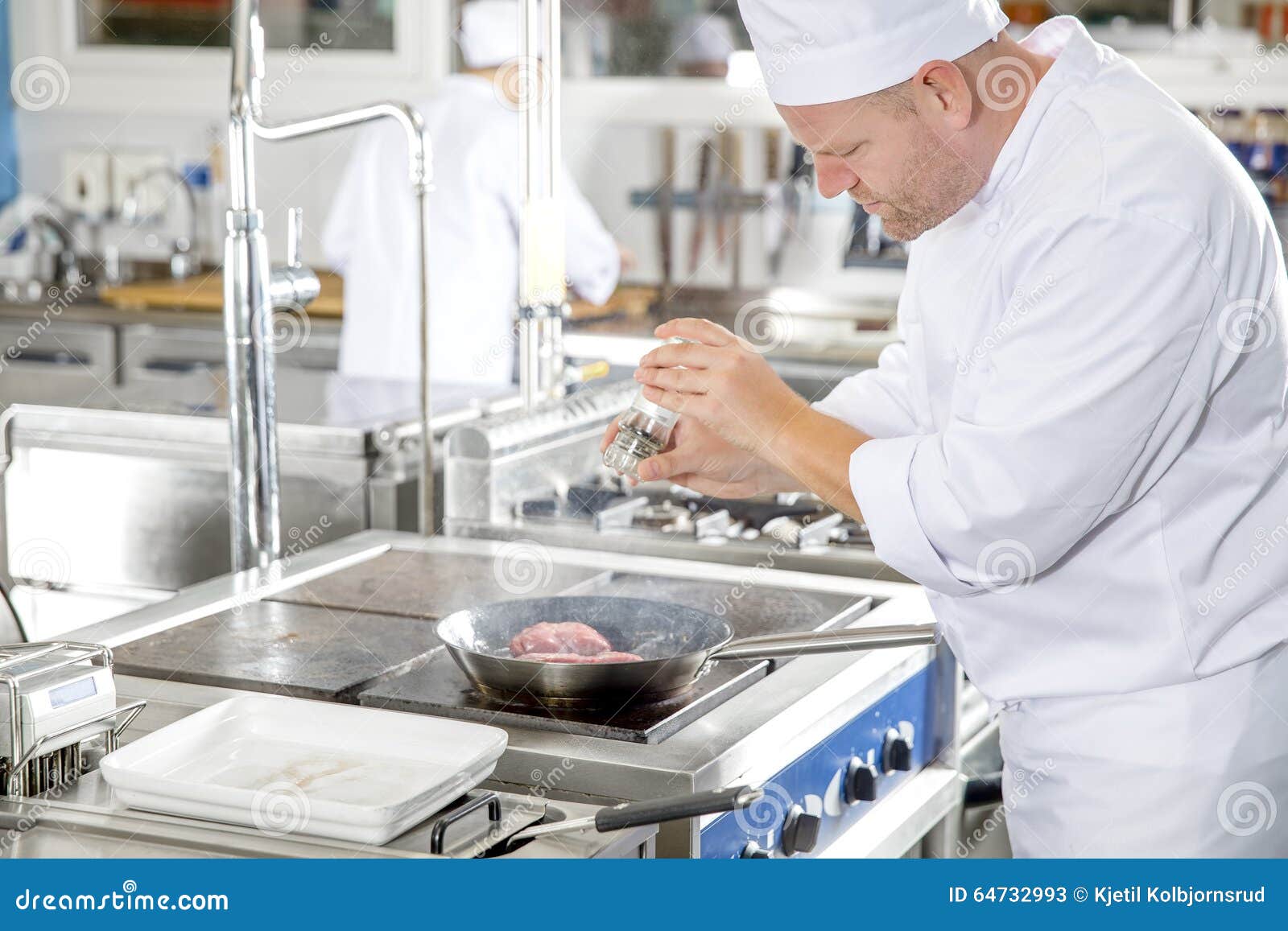 Professional Chef Adding Pepper on Steak in the Kitchen Stock Image ...