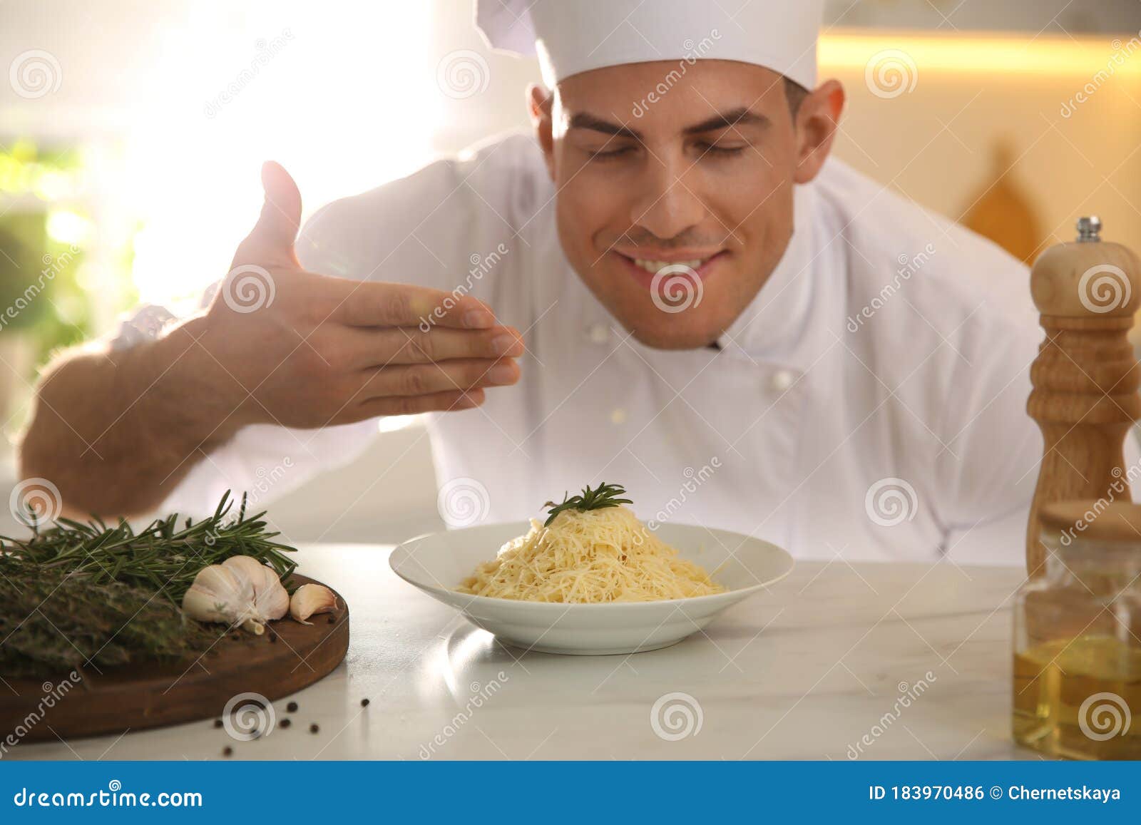 Chef Cooking at Table in Kitchen, Focus on Dish Stock Photo - Image of ...