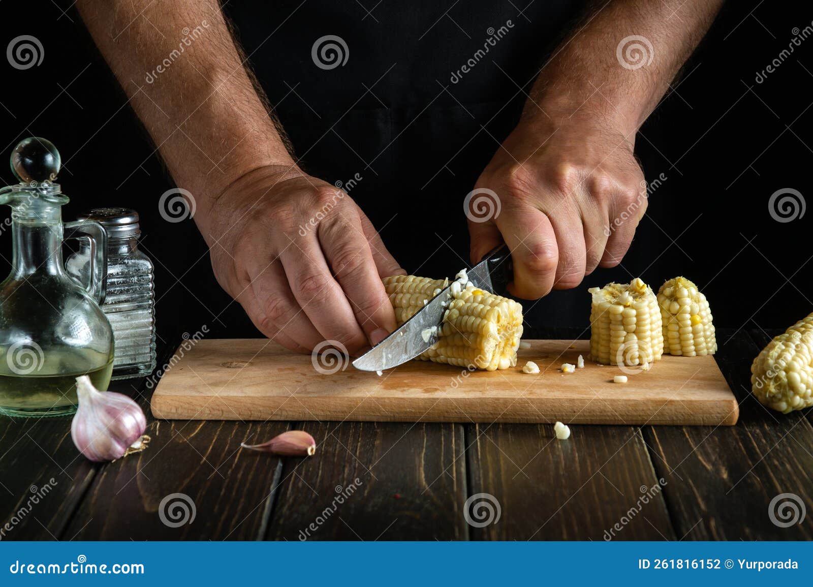 Professional Chef Cuts the Boiled Maize with a Knife. Corn is an ...