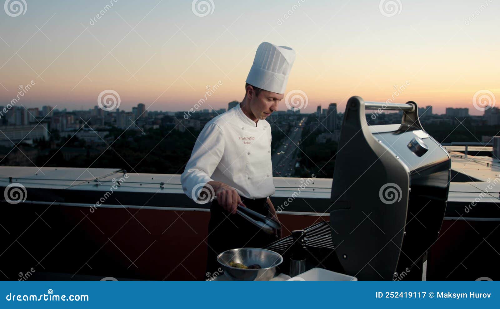 A Professional Chef Prepares a Barbecue on the Rooftop of a Skyscraper ...