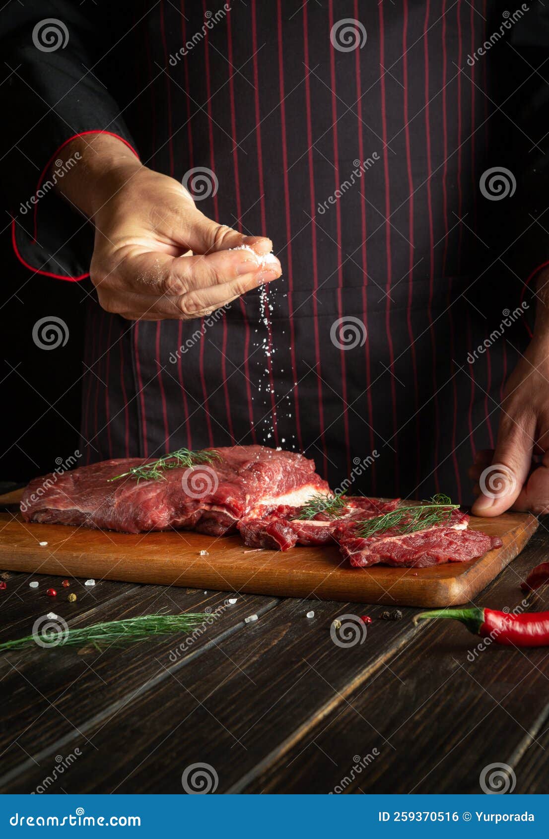 Professional Chef Salts Raw Fresh Beef before Roasting or Grilling ...
