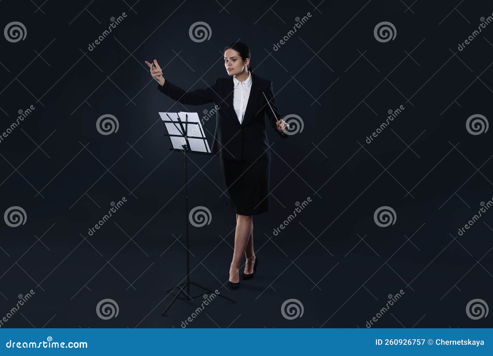 Professional Conductor with Baton and Note Stand on Dark Background ...