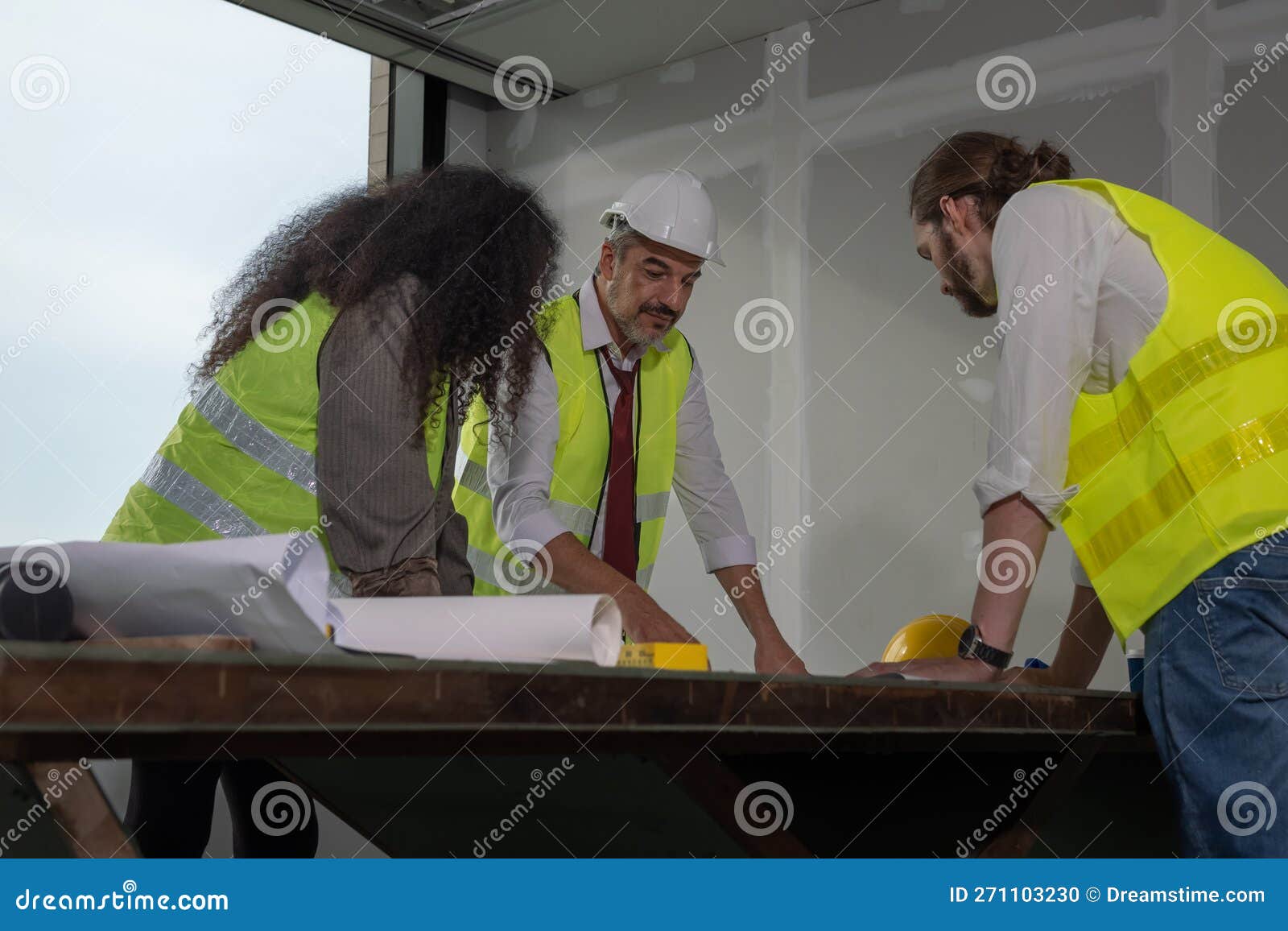 Professional Construction Engineers Team Using Blueprint of Project ...