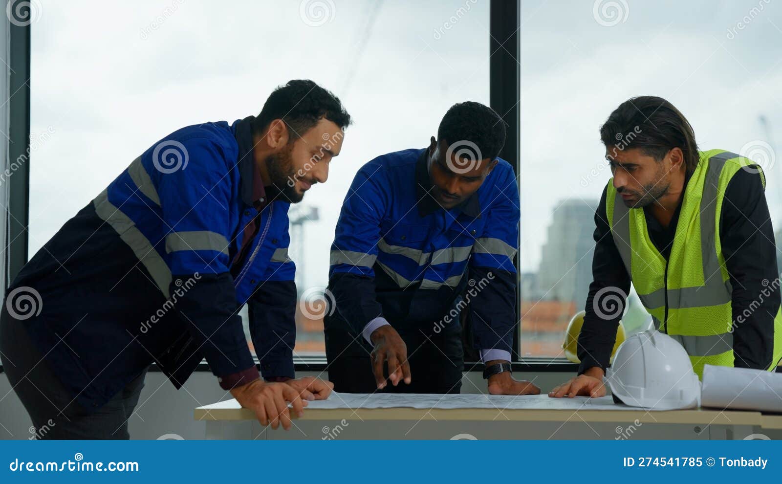 Professional Construction Engineers Using Blueprint Brainstorming Stock ...