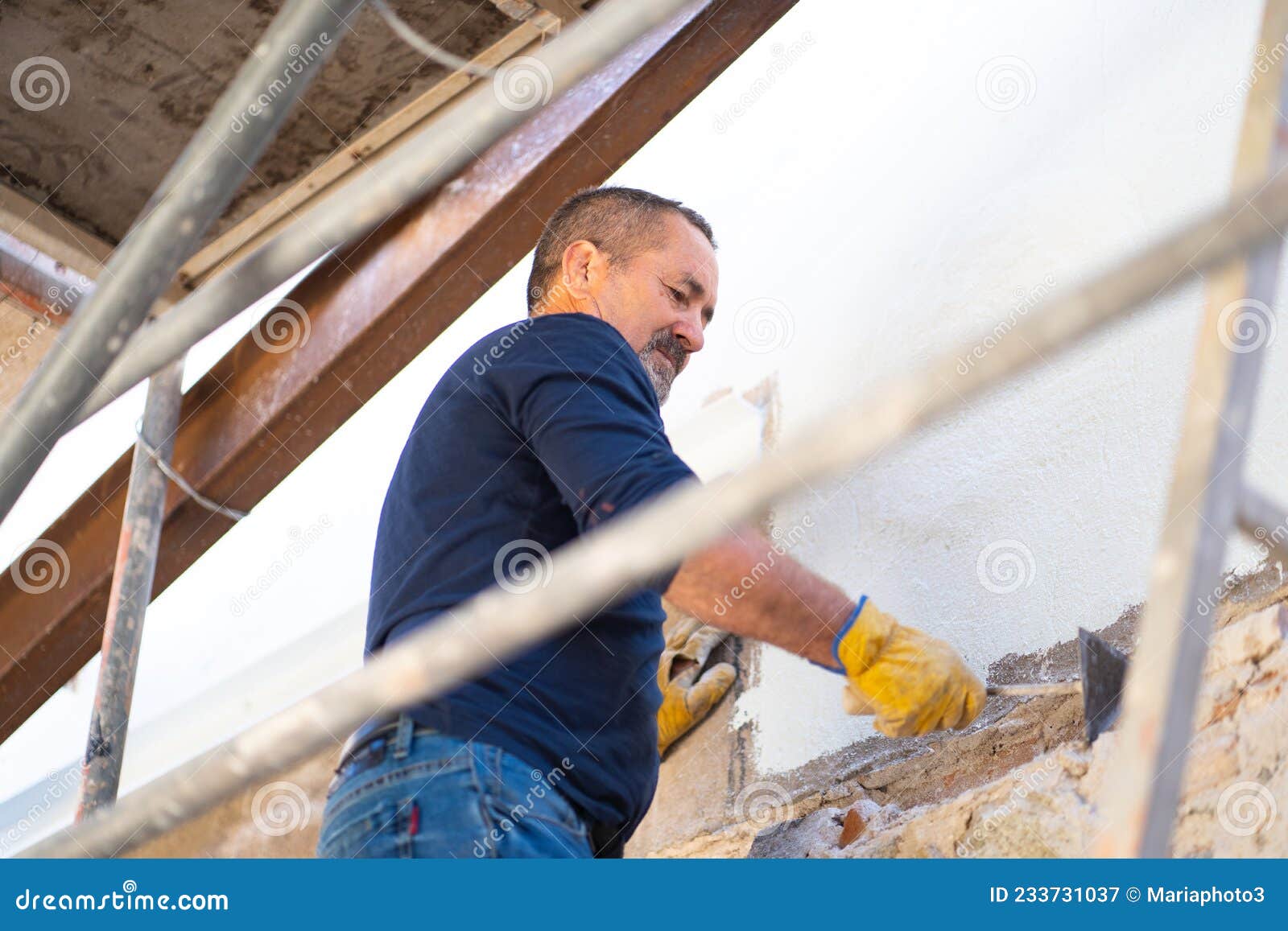 Construction Worker on a Ladder Fixing a Wall Stock Image - Image of ...