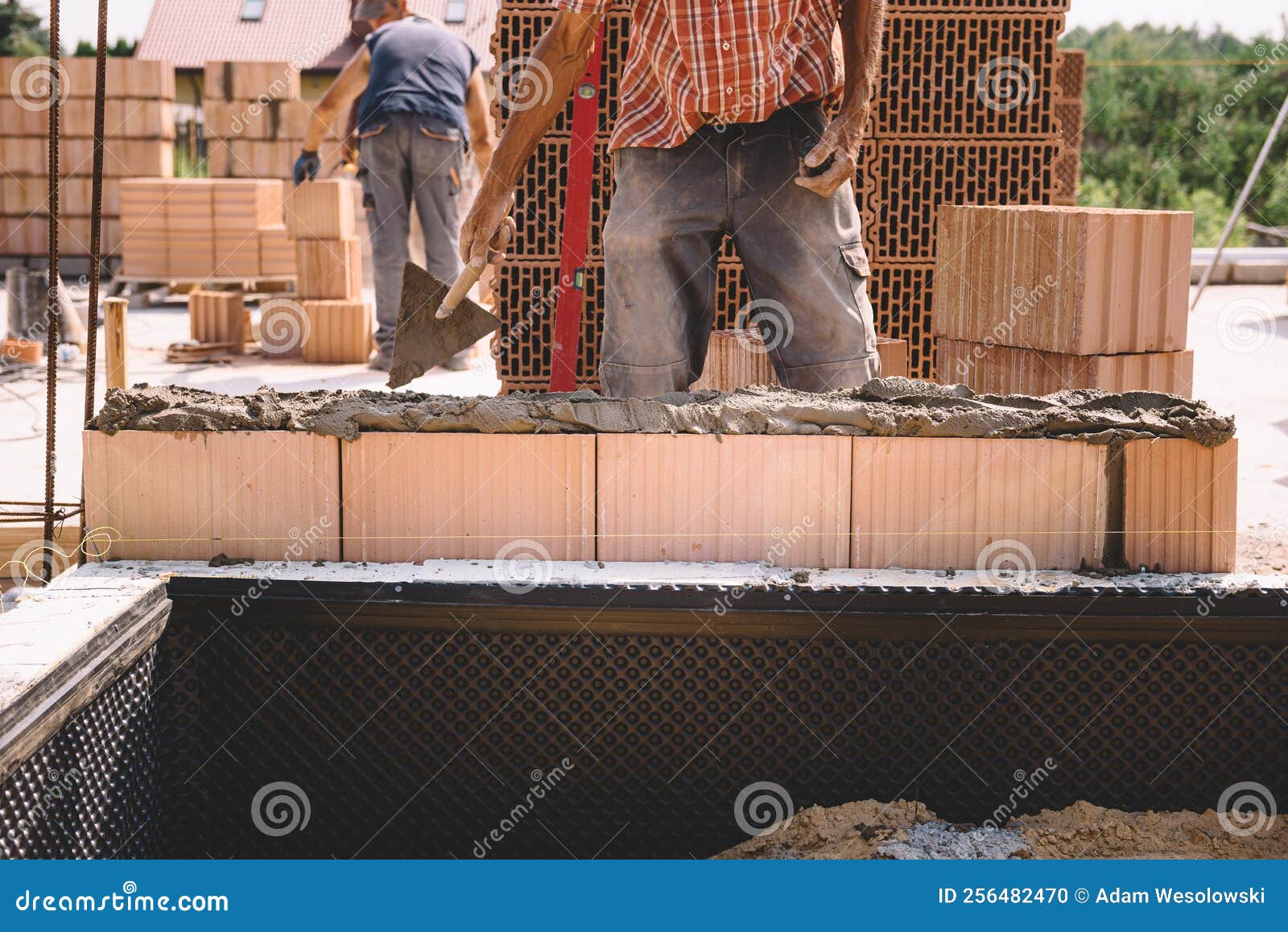 Professional Construction Worker Laying Bricks And Mortar - Building ...