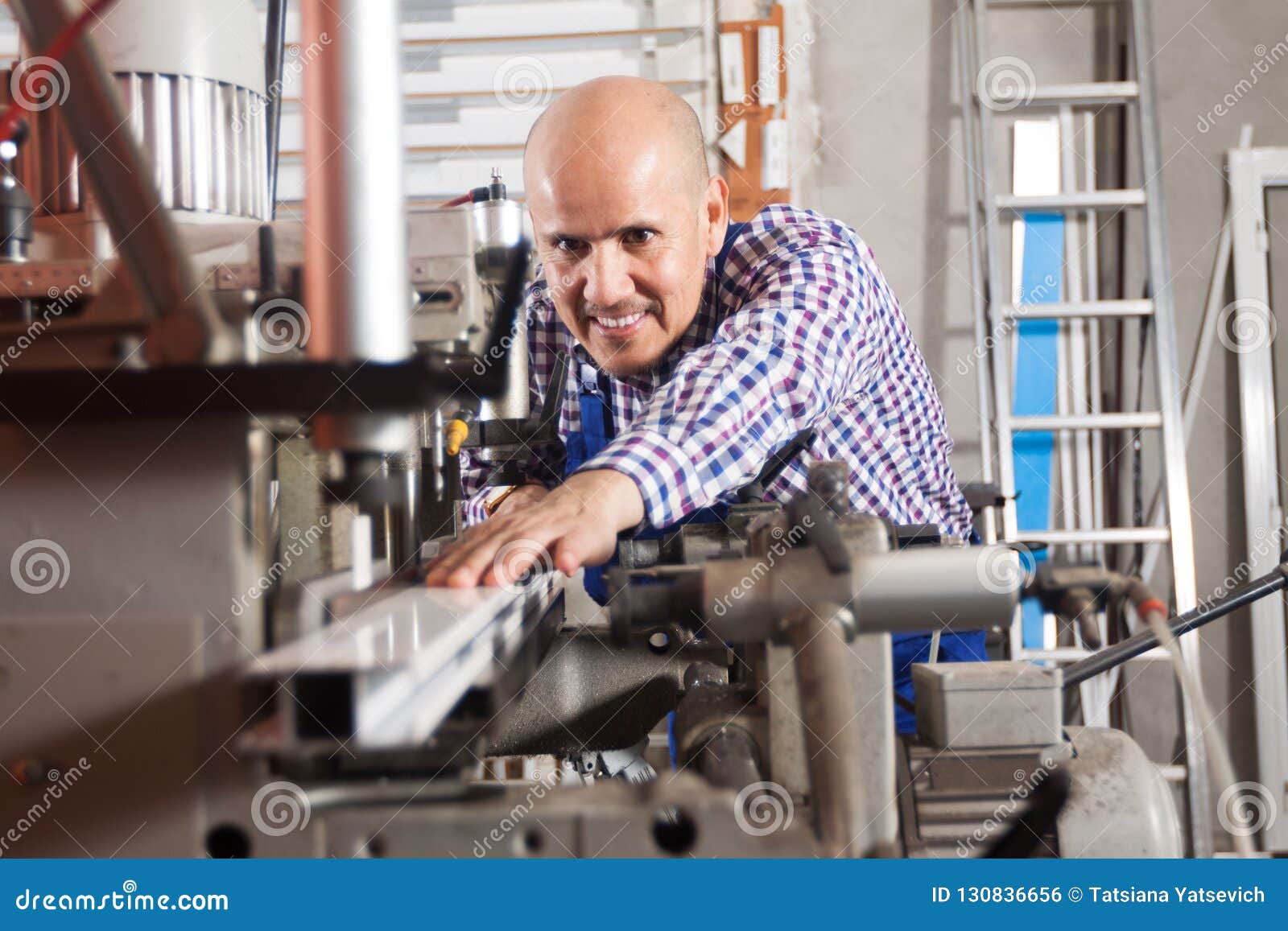 Professional Debonair Worker Toiling on a Machine in PVC Shop Stock ...