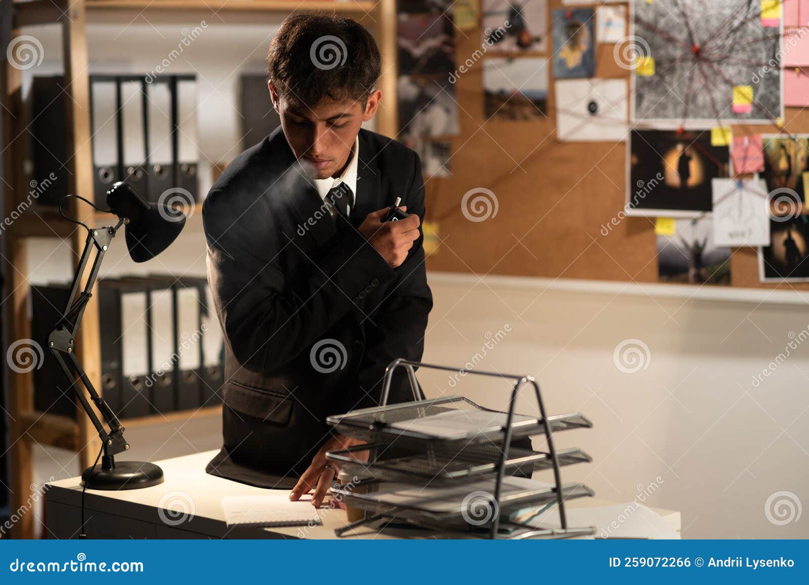 Professional Detective Working at Desk in Office Smoking Cigarette ...