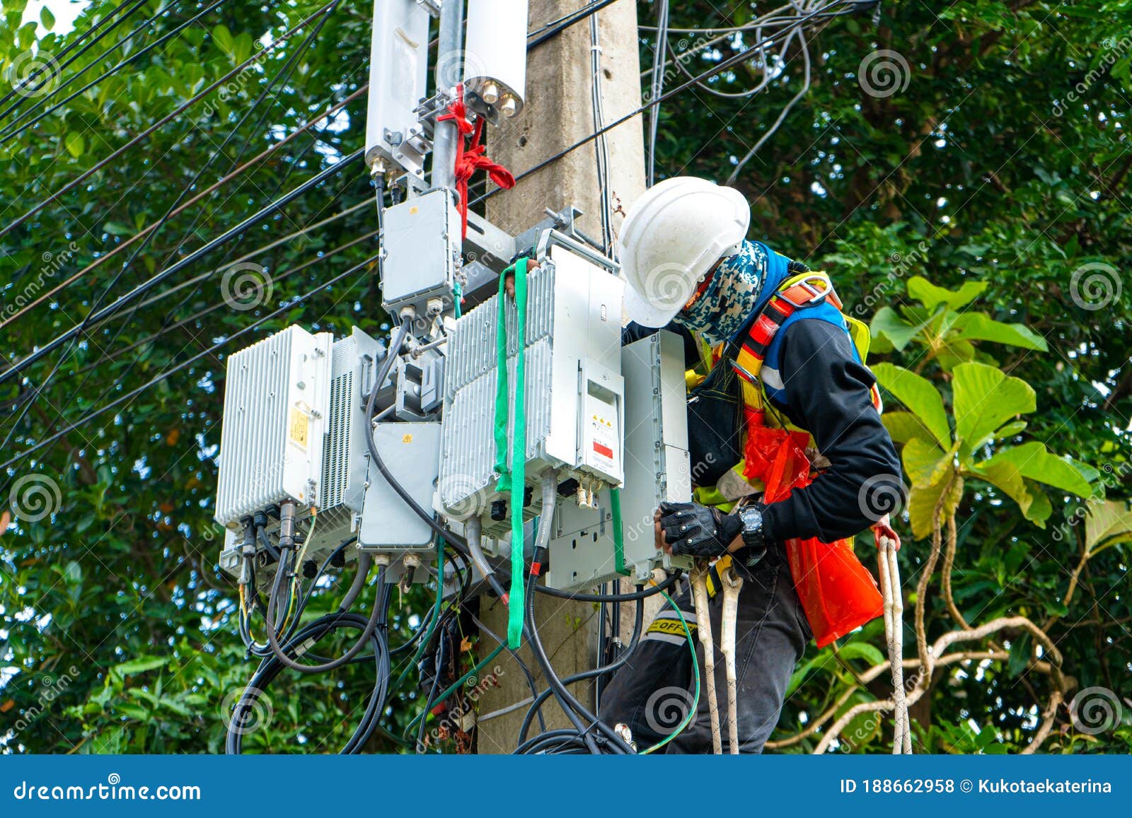 A Professional Electrician Performs Installation Work on a Pole. an ...