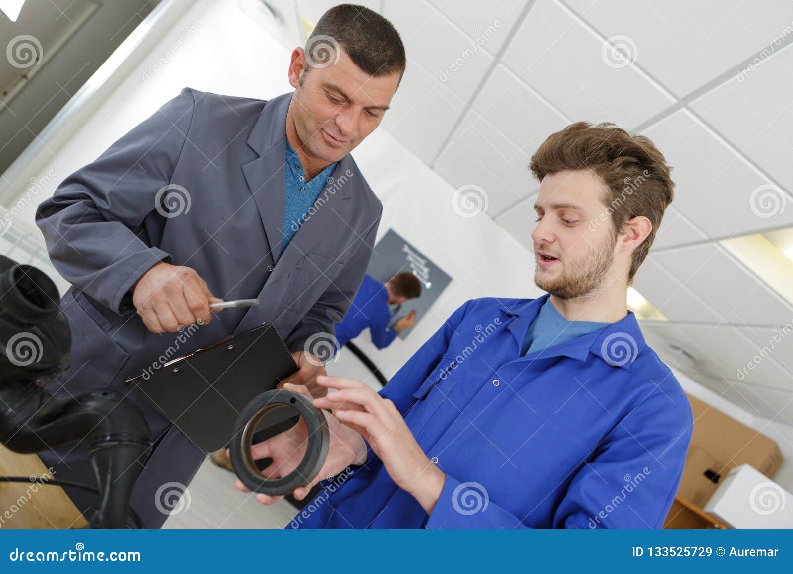 Professional Electrician with Student on Construction Site Stock Image ...