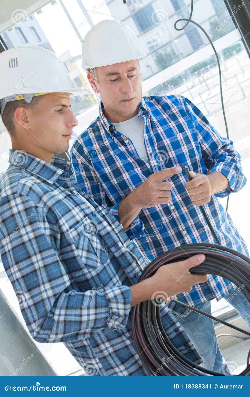 Professional Electrician with Student on Construction Site Stock Image ...