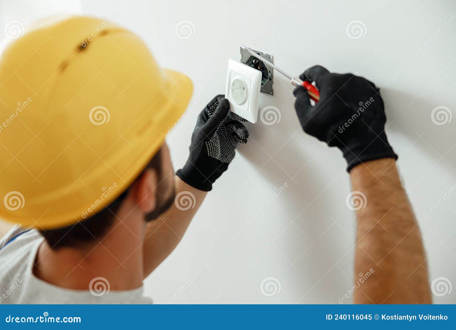 Professional Electrician in Uniform Using Screwdriver while Installing ...