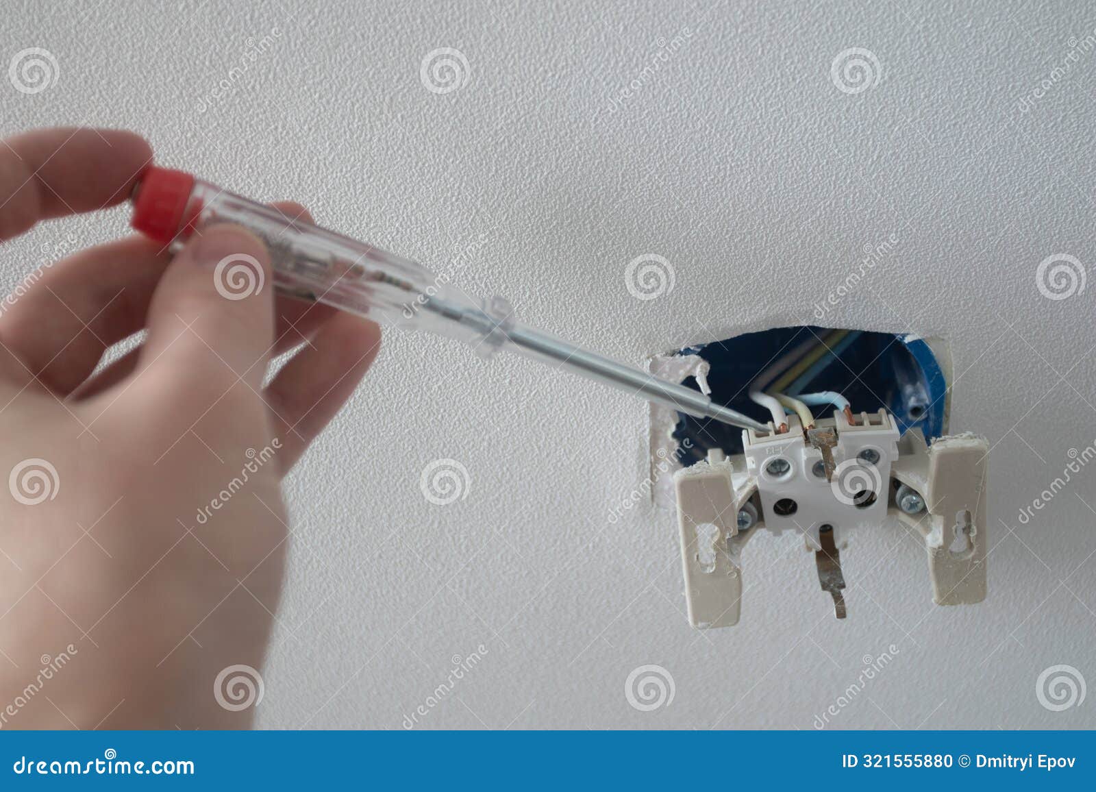 Professional Electrician Working on a Home Electrical System, he is ...