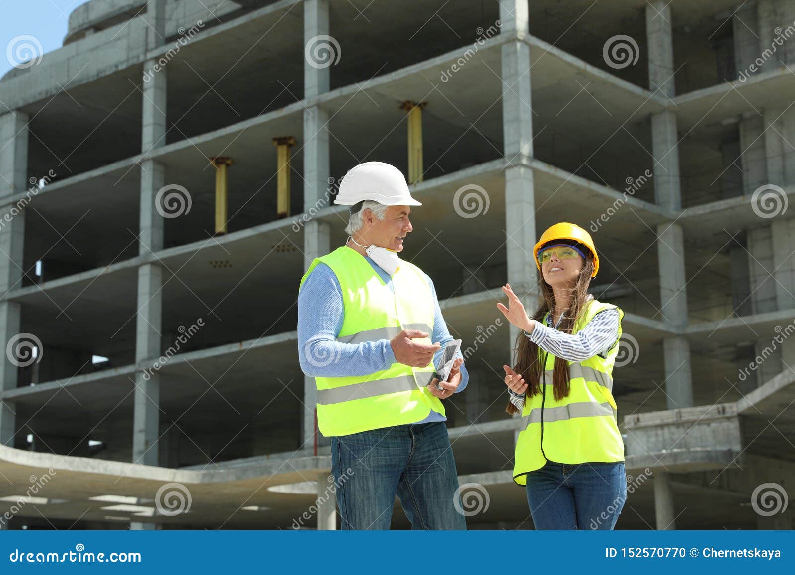 Professional Engineer and Foreman with Tablet in Safety Equipment at ...