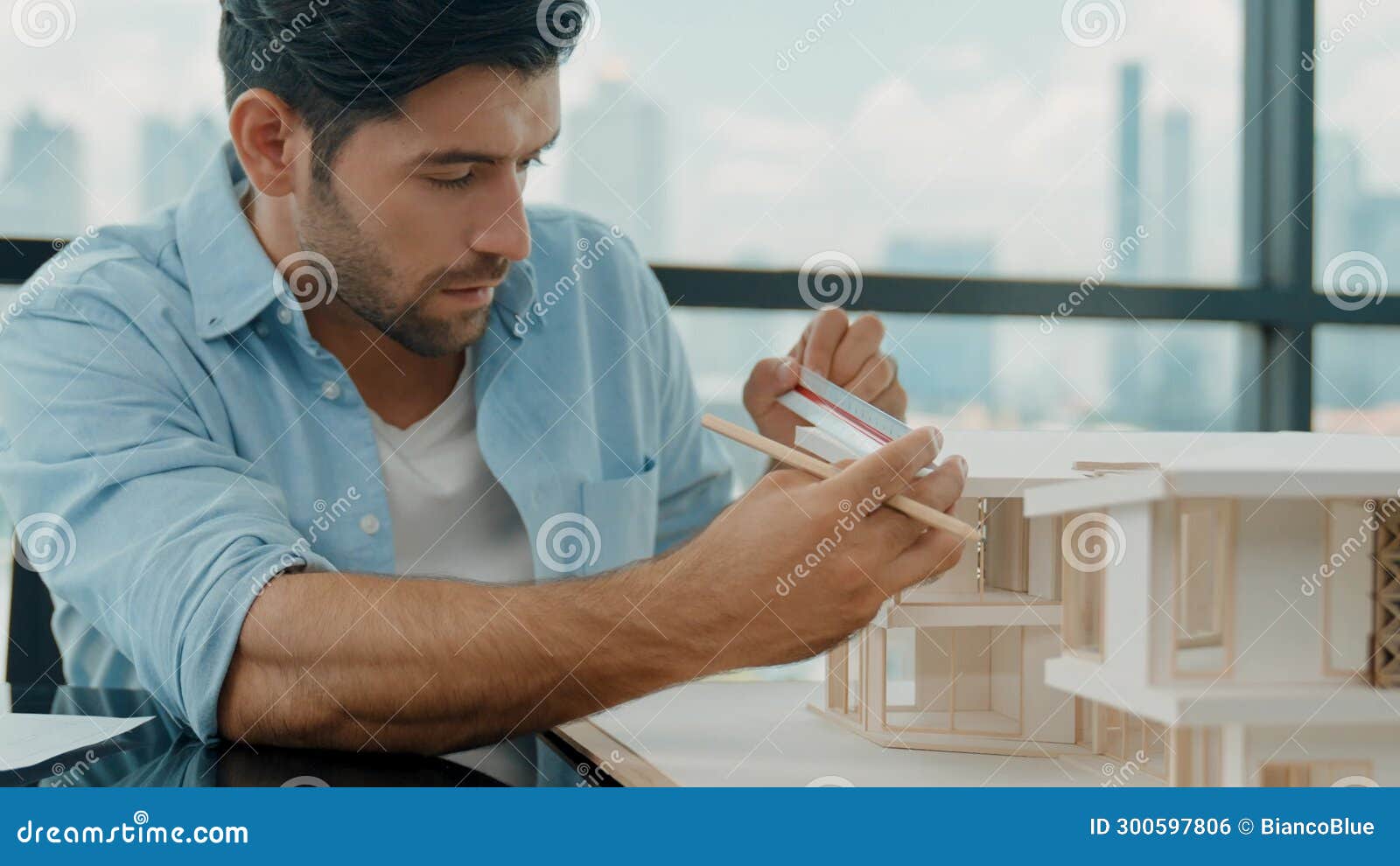 Skilled Engineer Looking at Blueprint while Measure House Model ...