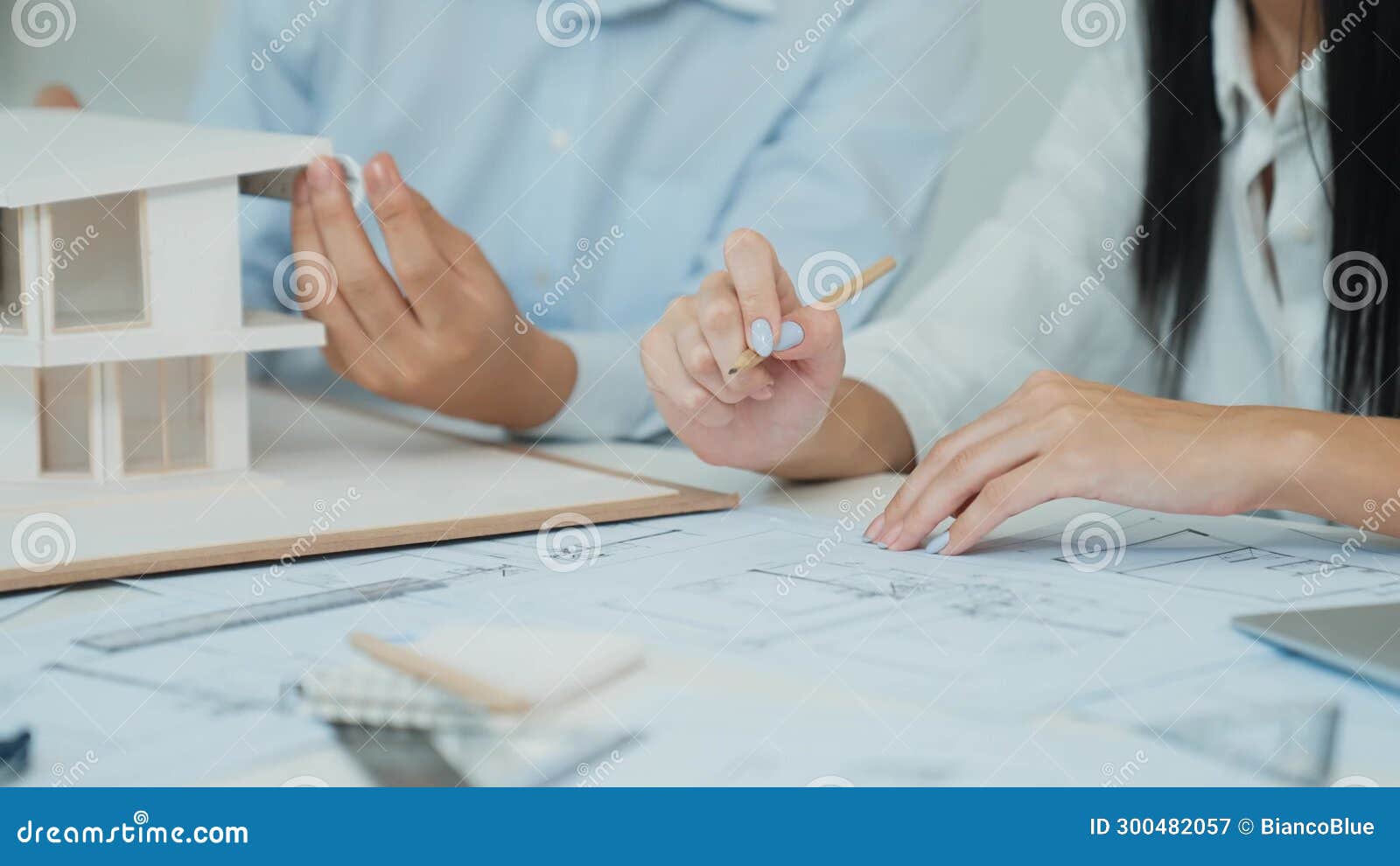 Engineer Measures Model while Skilled Designer Writes at Blueprint ...