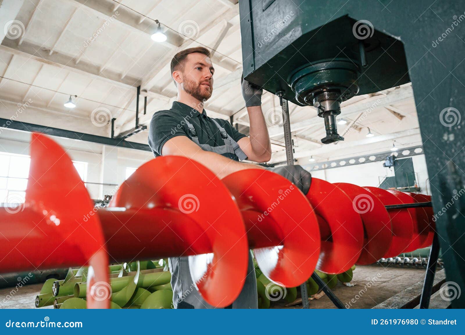 Professional Engineer Operating Machine. Man in Uniform is in ...