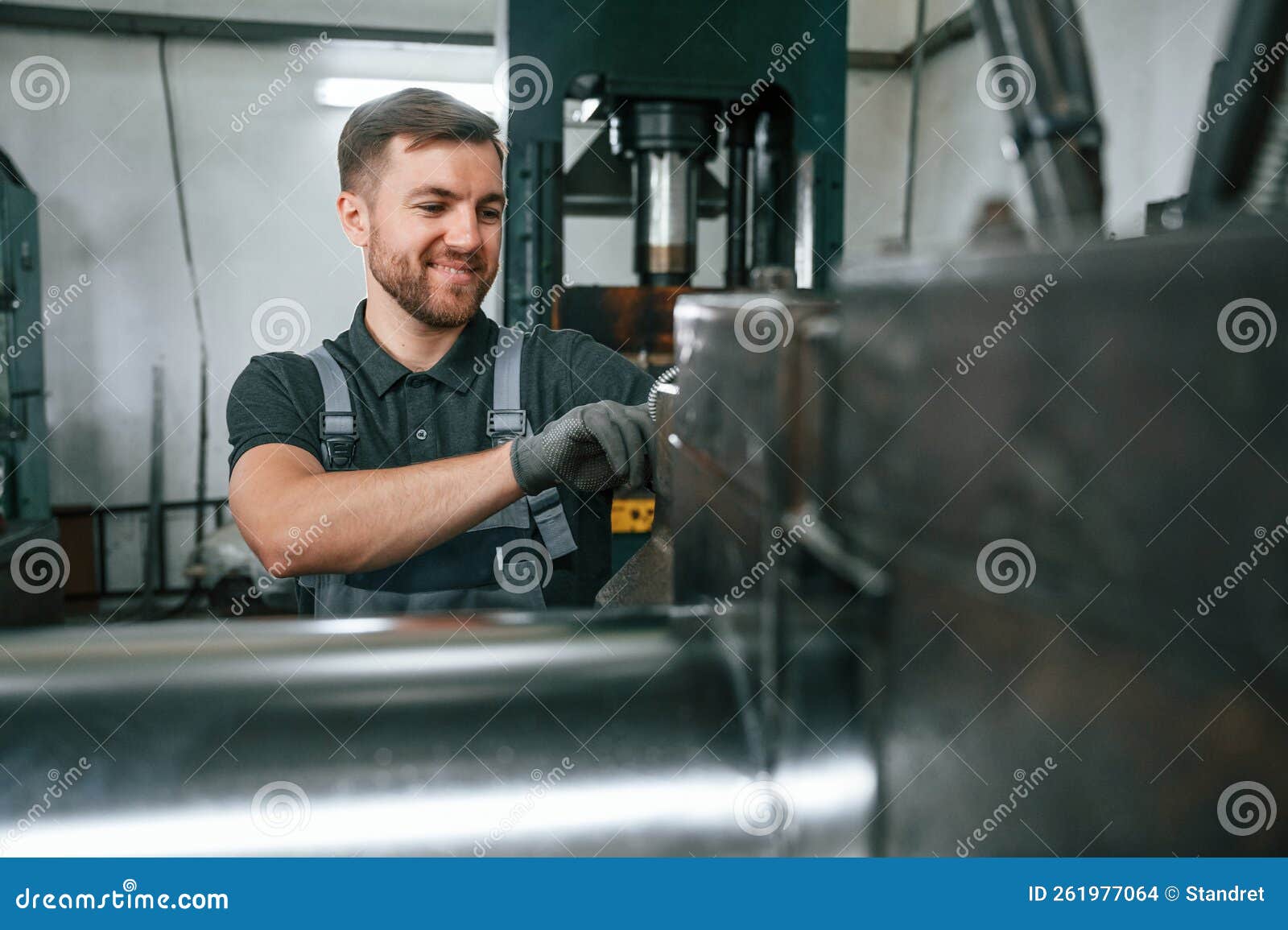 Professional Engineer Operating Machine. Man in Uniform is in ...