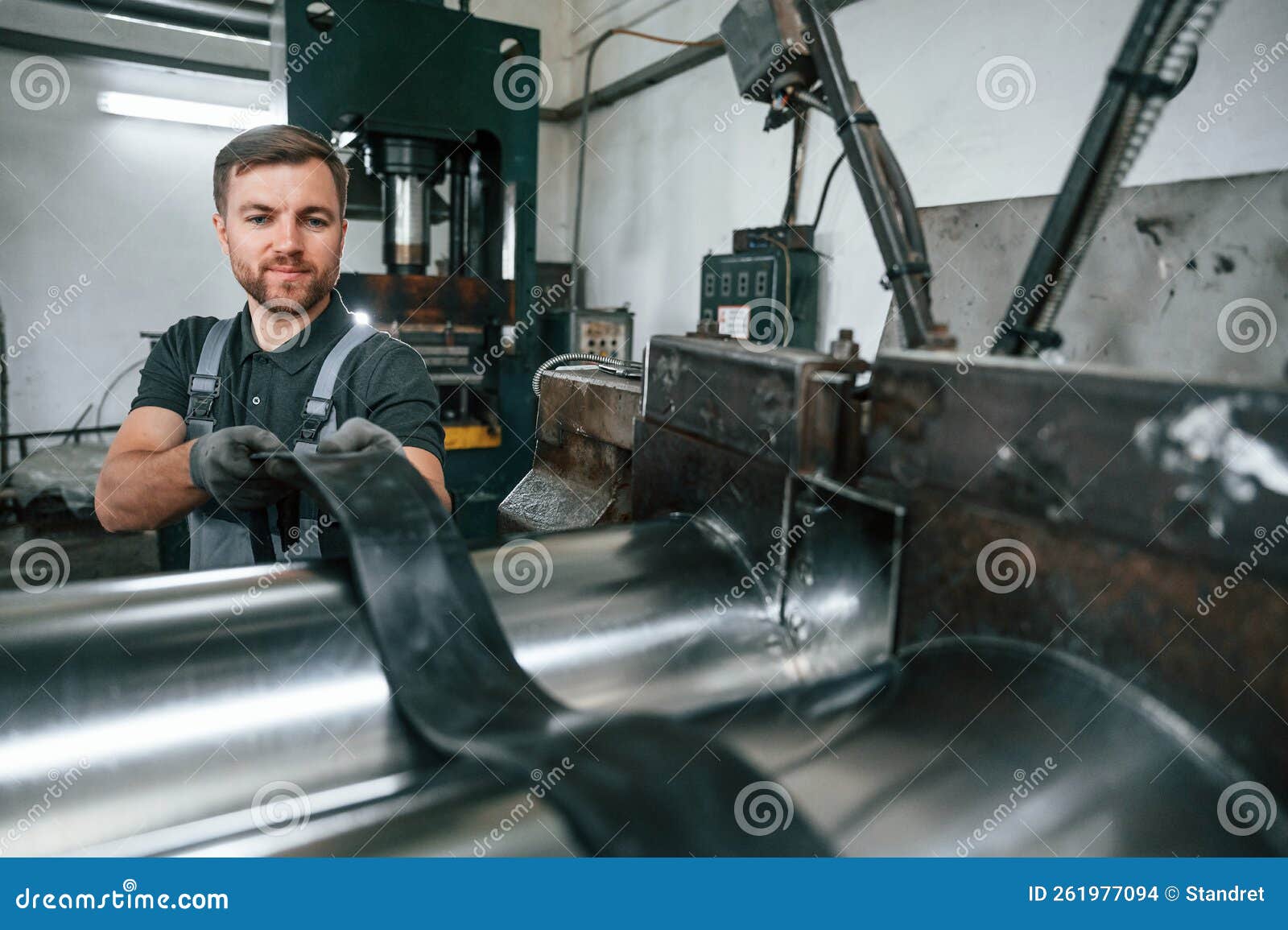 Professional Engineer Operating Machine. Man in Uniform is in ...