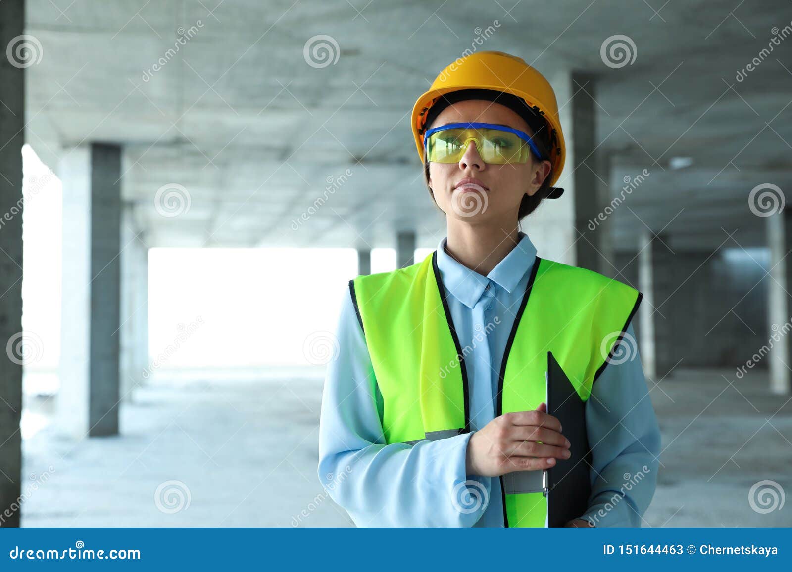 Professional Engineer in Safety Equipment with Clipboard at ...